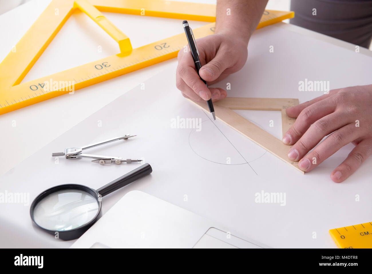 Male engineer working on drawings and blueprints Stock Photo - Alamy