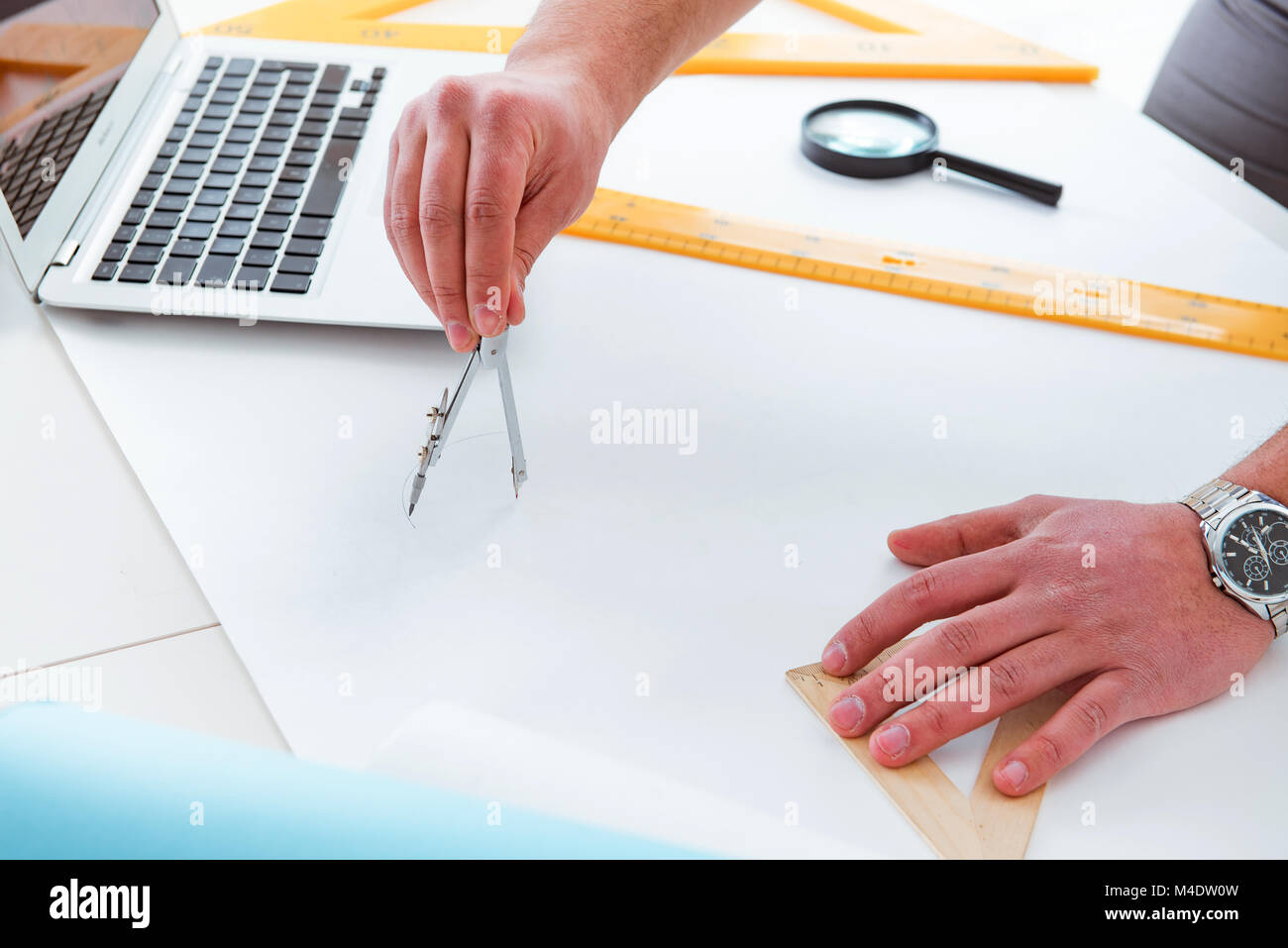 Male engineer working on drawings and blueprints Stock Photo - Alamy