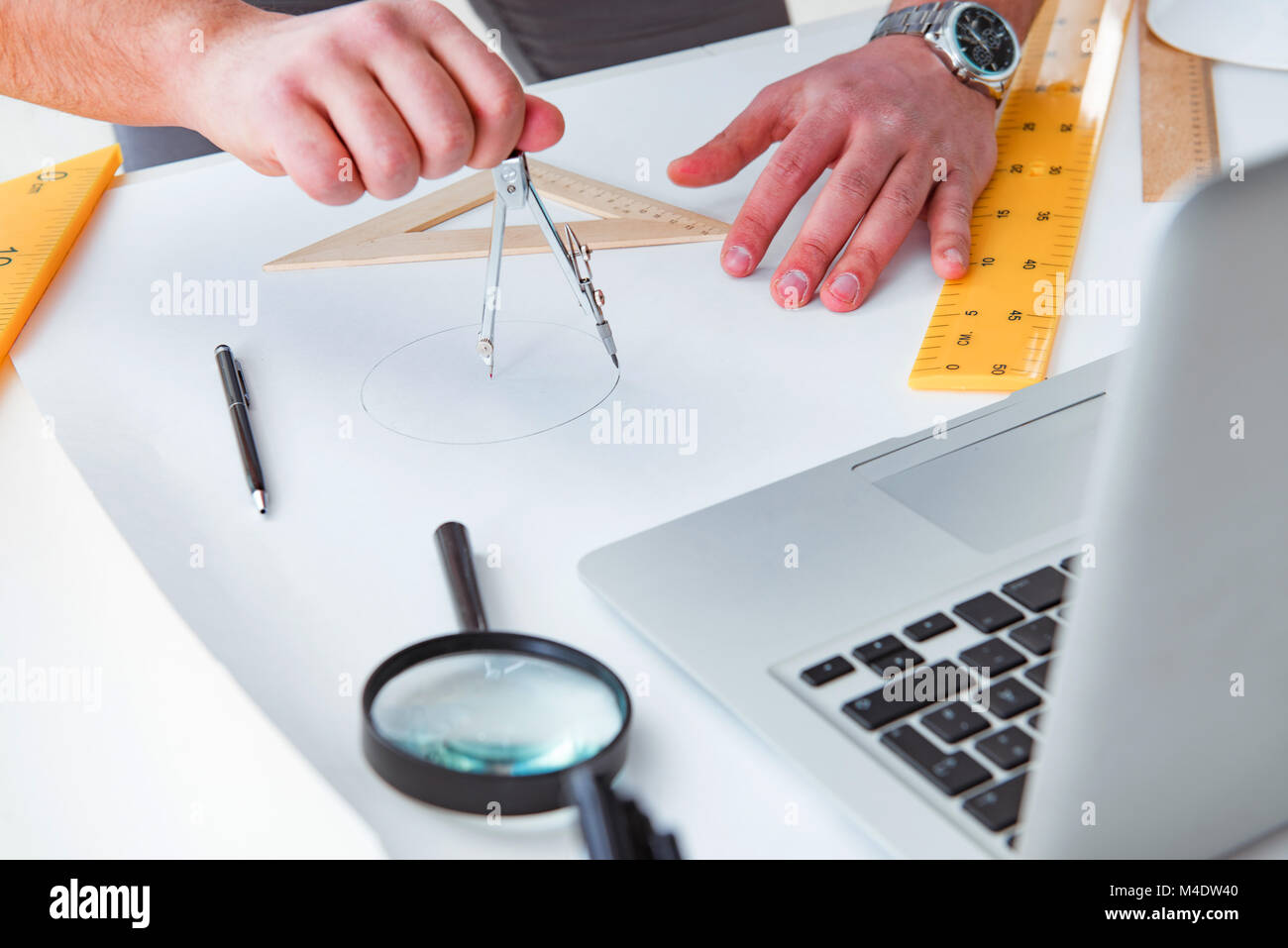 Male engineer working on drawings and blueprints Stock Photo - Alamy