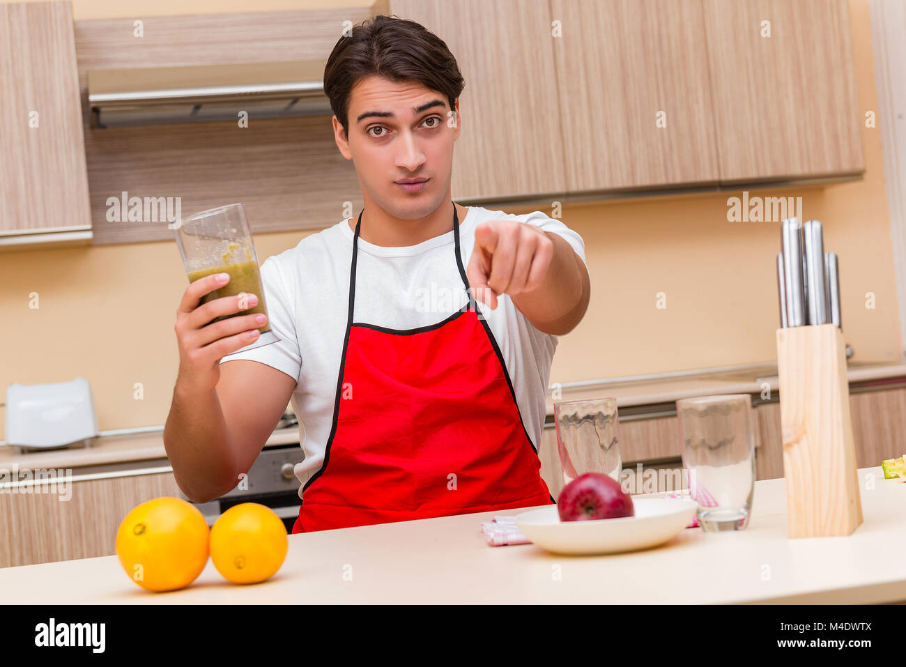 Handsome man working at the kitchen Stock Photo - Alamy