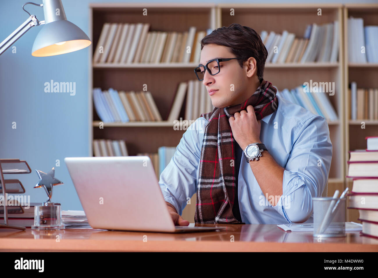 Young book writer writing in library Stock Photo - Alamy