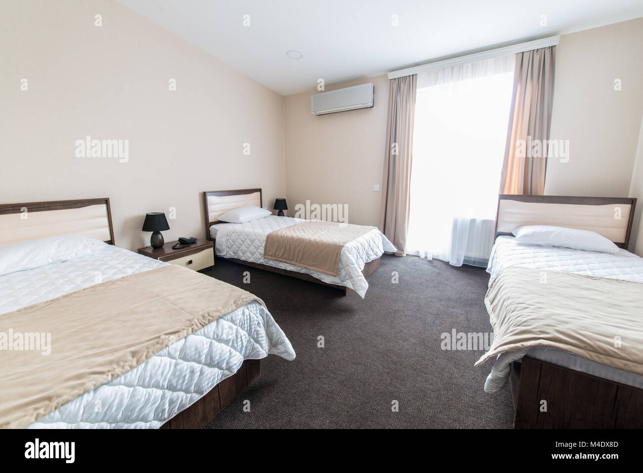 Triple room in modern hotel Stock Photo - Alamy