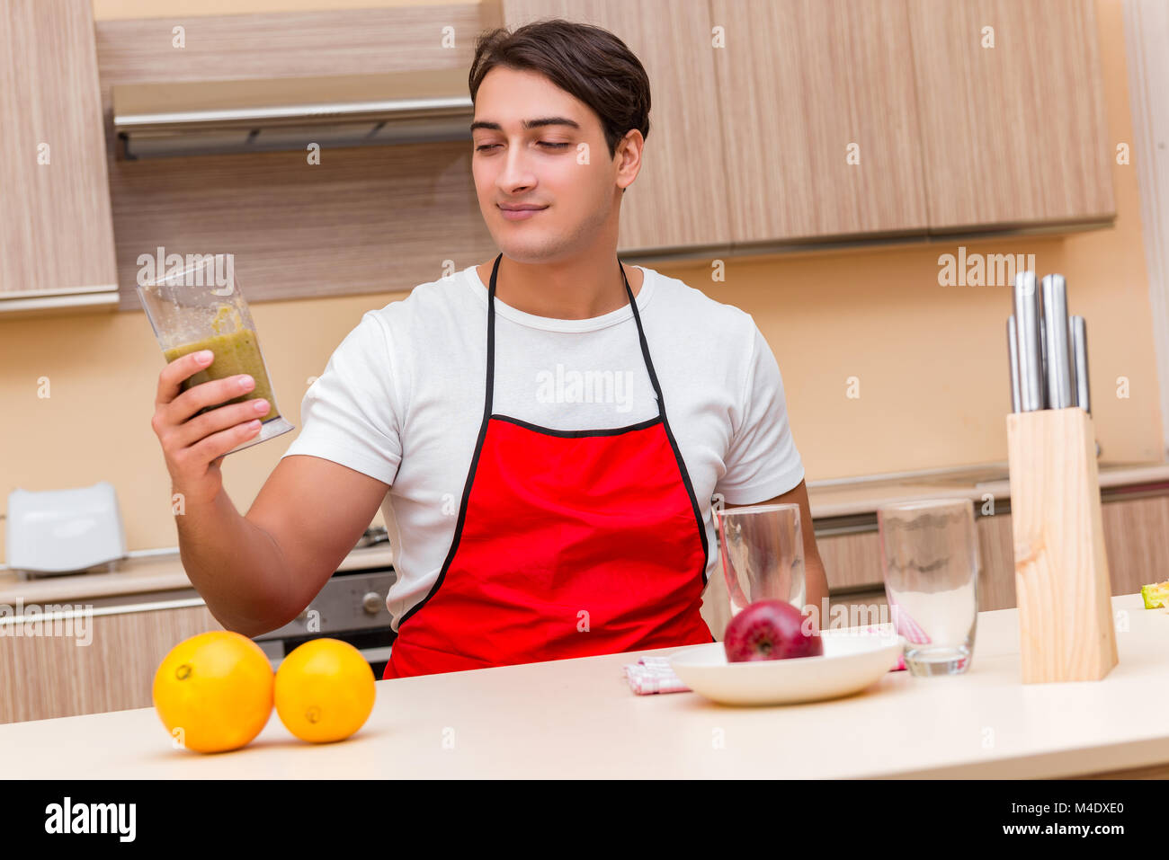Handsome man working at the kitchen Stock Photo - Alamy