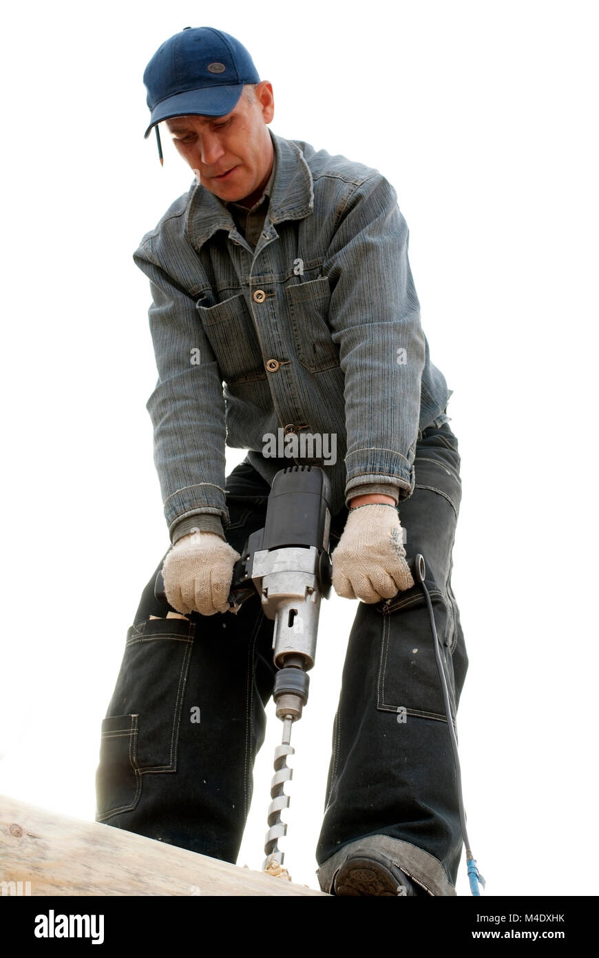 Carpenter drills a log on the construction of log cabin Stock Photo - Alamy