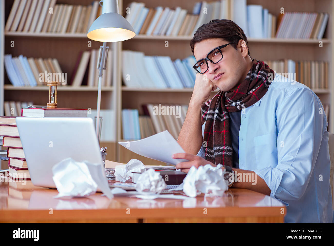Young book writer writing in library Stock Photo - Alamy