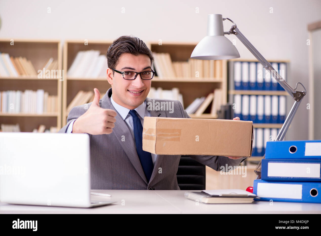 Businessman opening package in office hi-res stock photography and ...