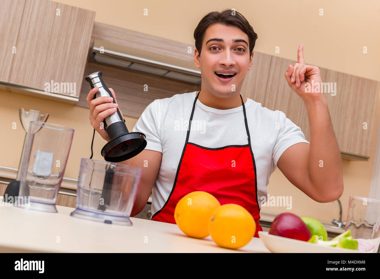 Handsome man working at the kitchen Stock Photo - Alamy