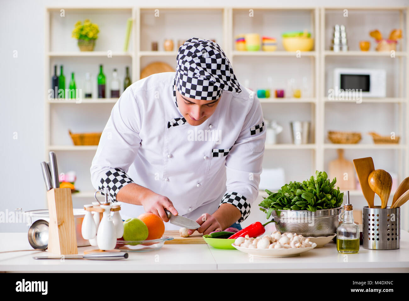 Young male cook working in the kitchen Stock Photo - Alamy