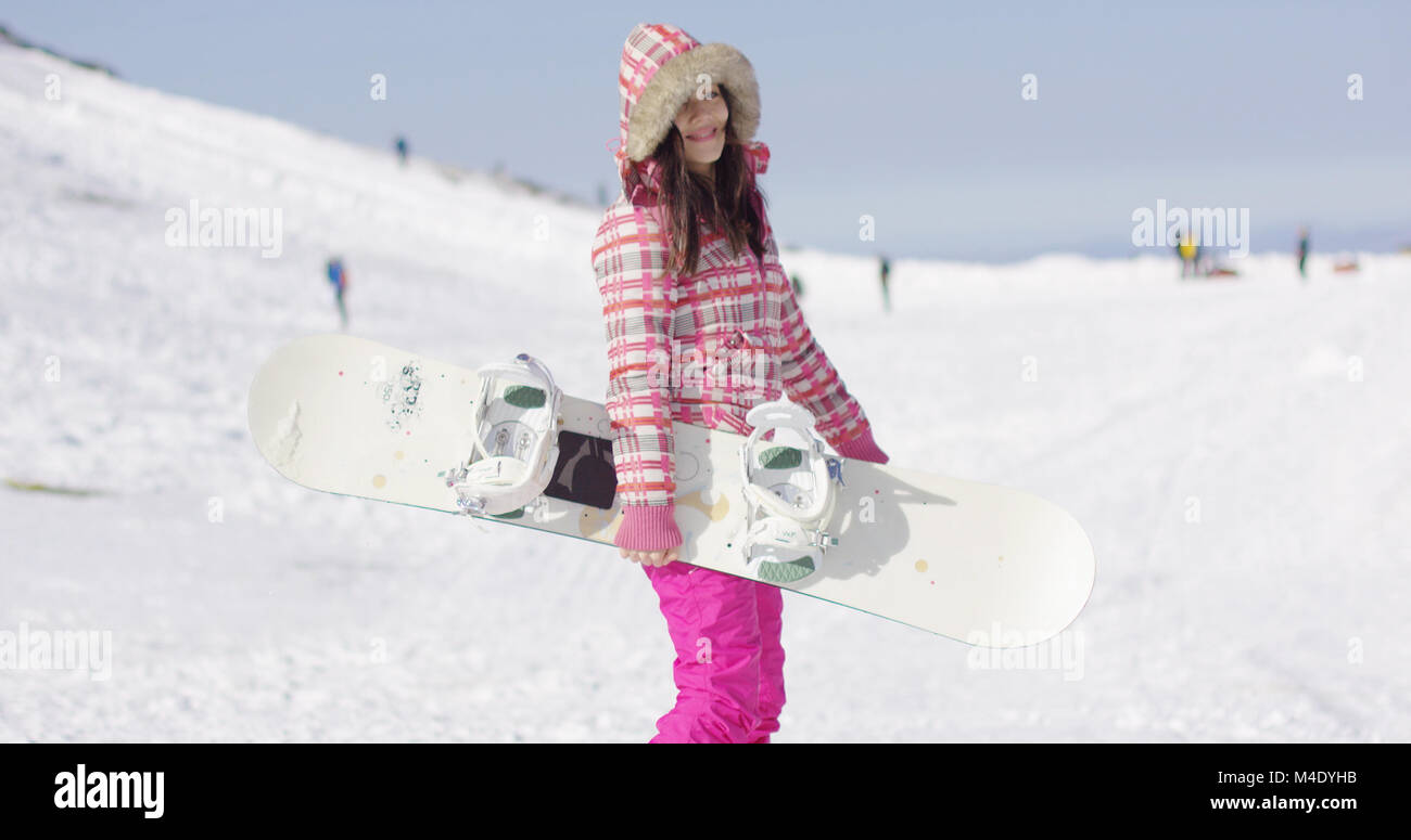 Happy cute female snowboarder on ski slope Stock Photo - Alamy