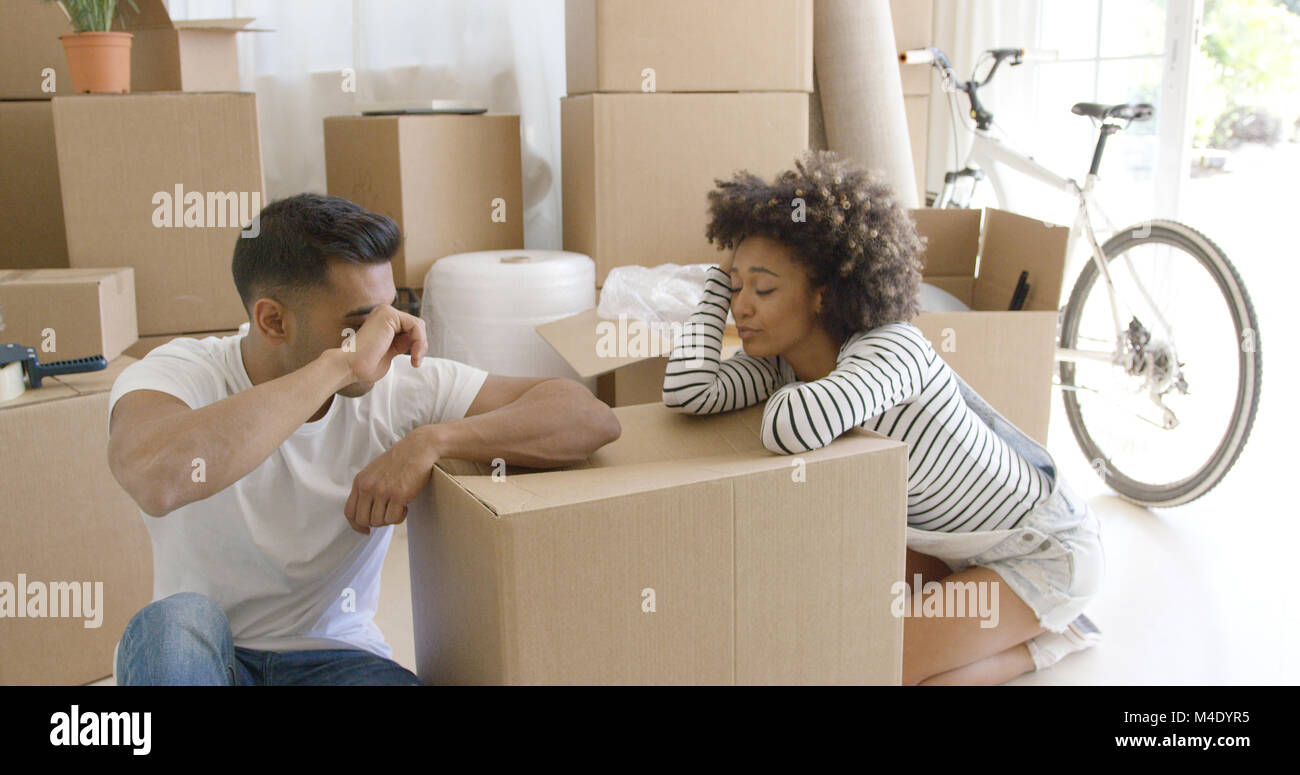 Exhausted couple taking a break from packing Stock Photo - Alamy