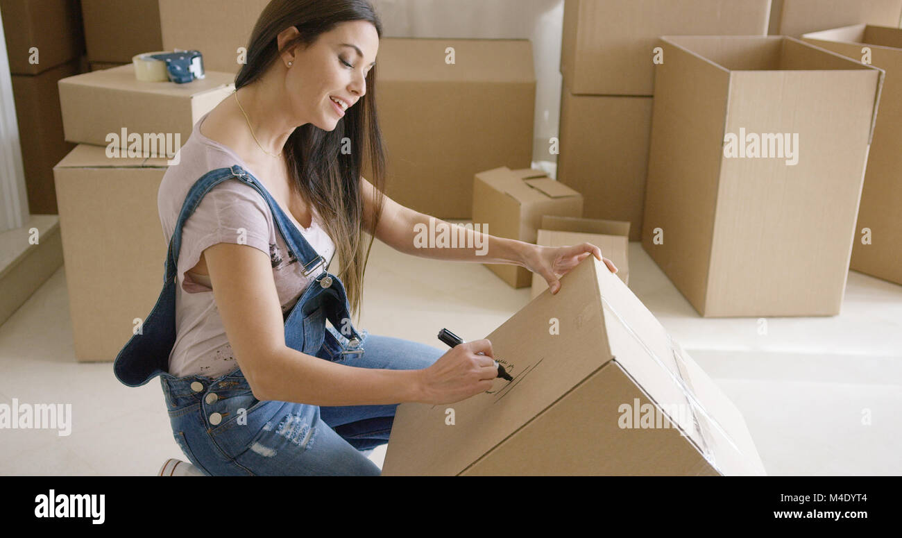 Attractive woman moving house and packing Stock Photo - Alamy