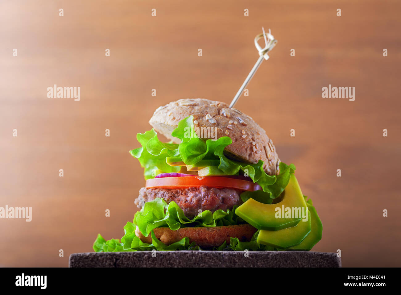 Delicious homemade burger on rustic wooden desk Stock Photo - Alamy