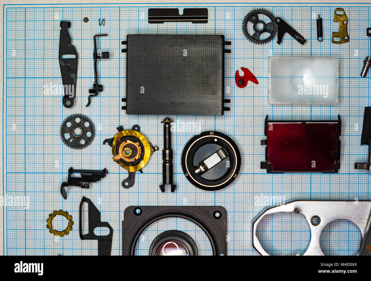 parts are completely disassembled old retro film SLR camera on graph ...