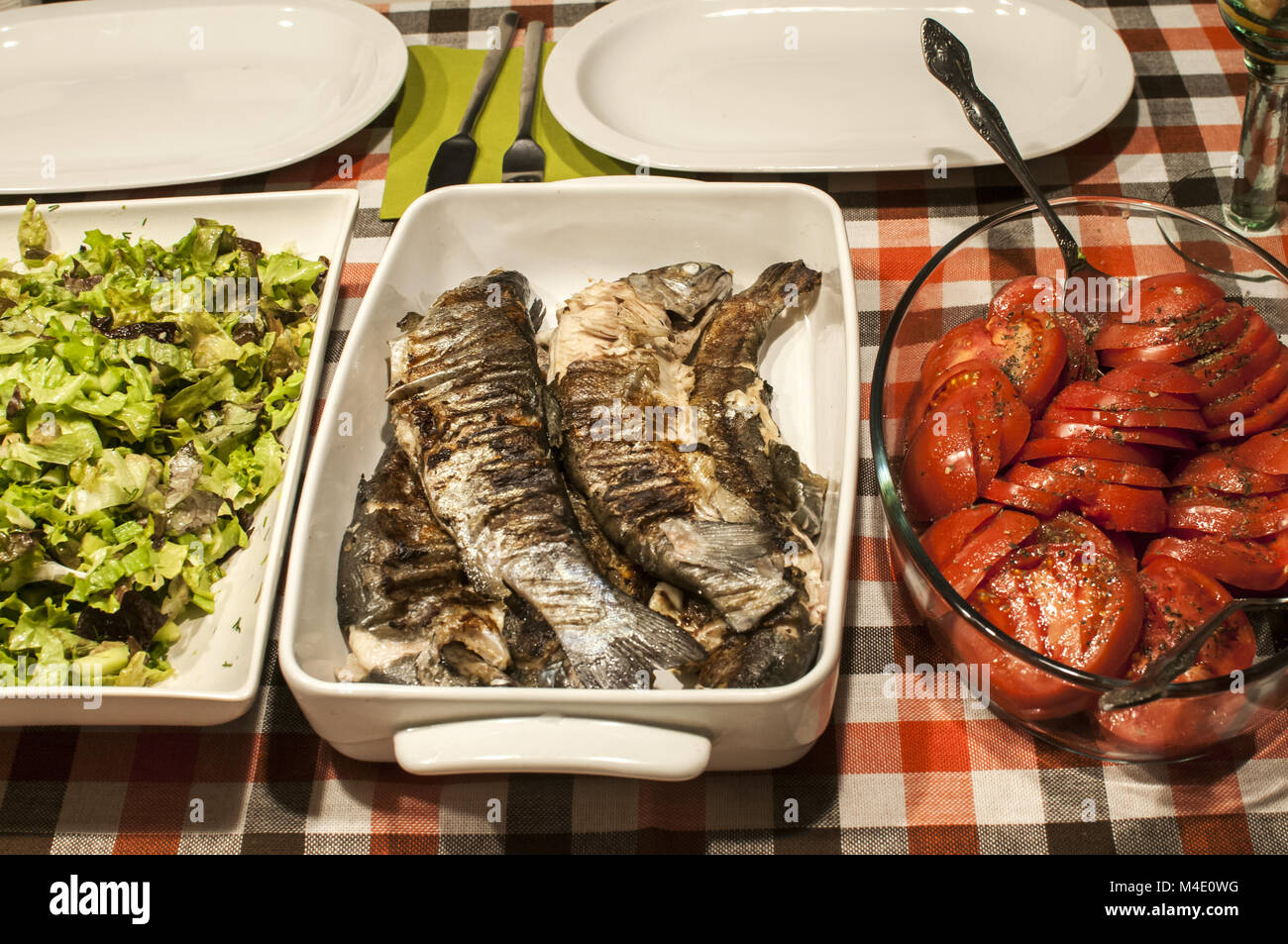 Home table with full dishes Stock Photo - Alamy
