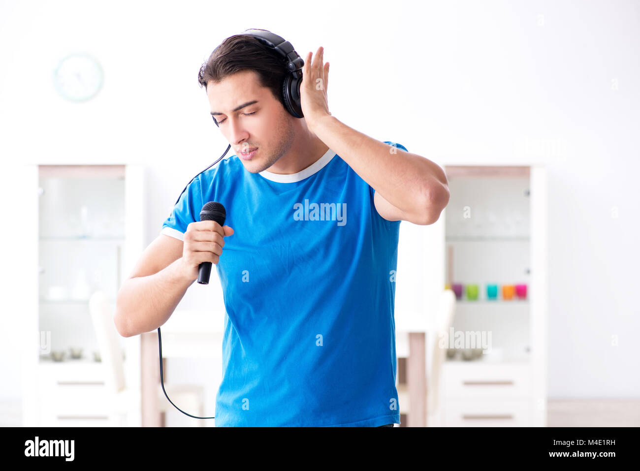 Young man singing at home karaoke Stock Photo - Alamy
