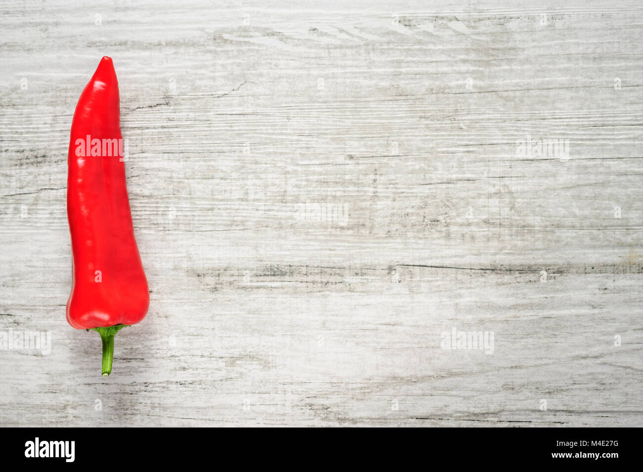 Sweet red Kapia peppers on a white wood background Stock Photo - Alamy