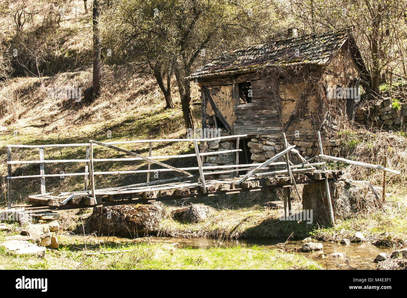 Old grunge village house and bridge Stock Photo - Alamy