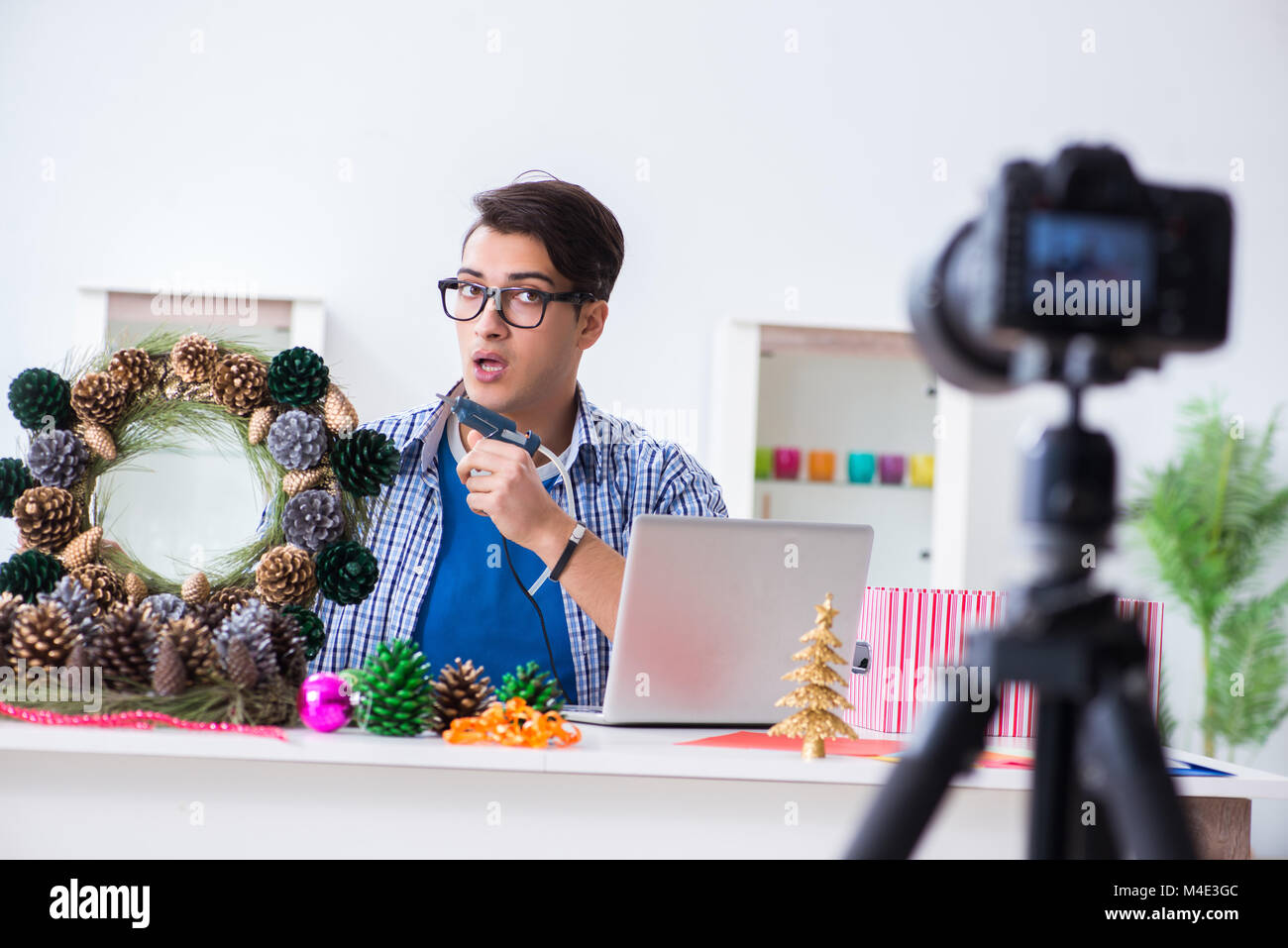 Young vlogger recording video doing christmas decoration Stock Photo ...