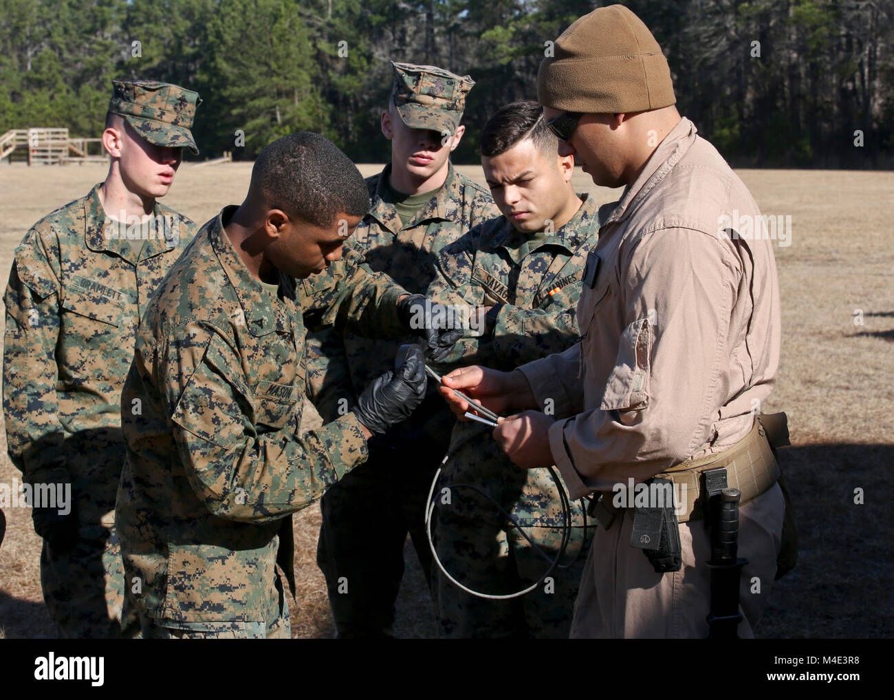 Staff Sgt. Steve Gomez watches as Lance Cpl. Darius Mason practices ...