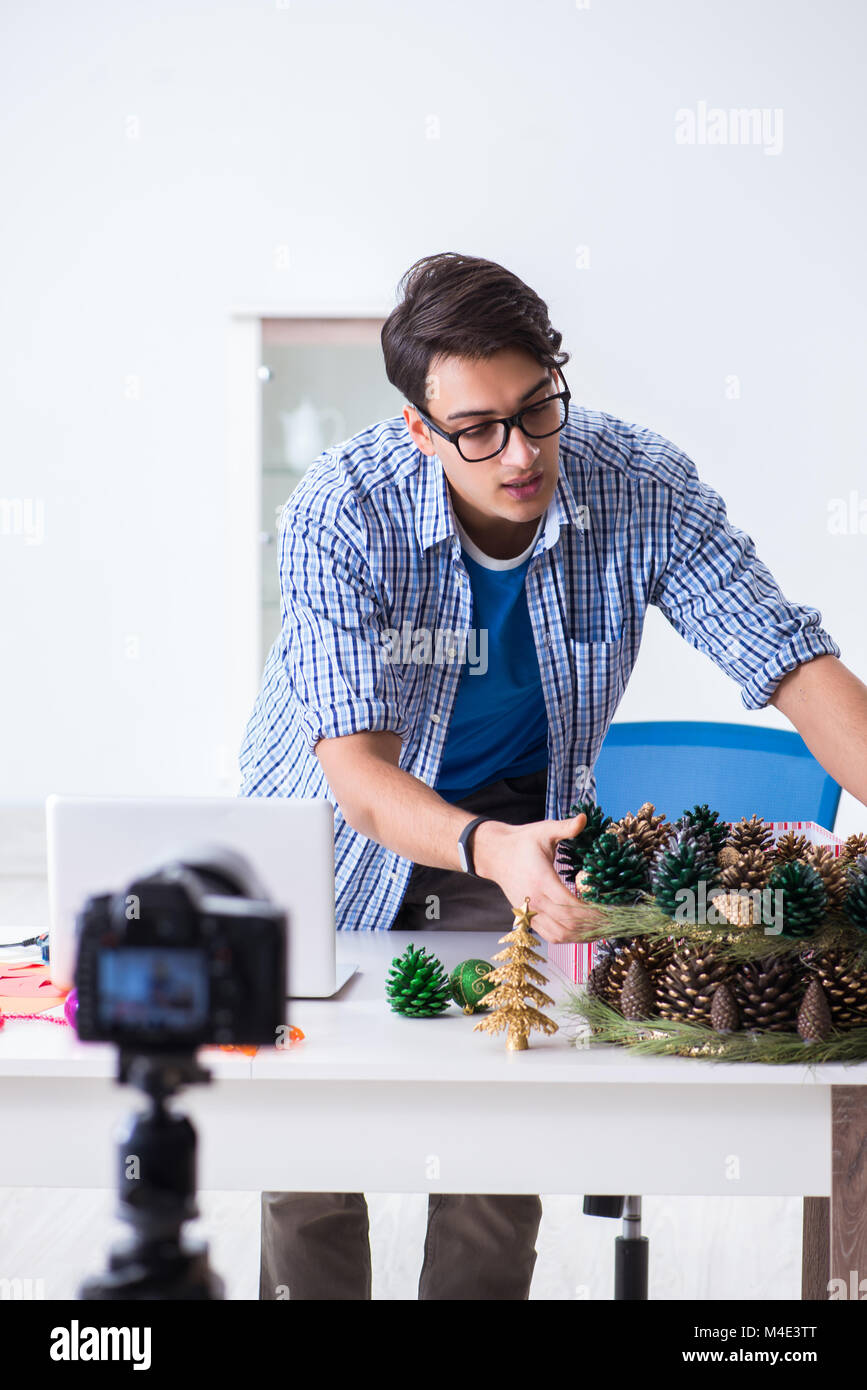 Young vlogger recording video doing christmas decoration Stock Photo ...