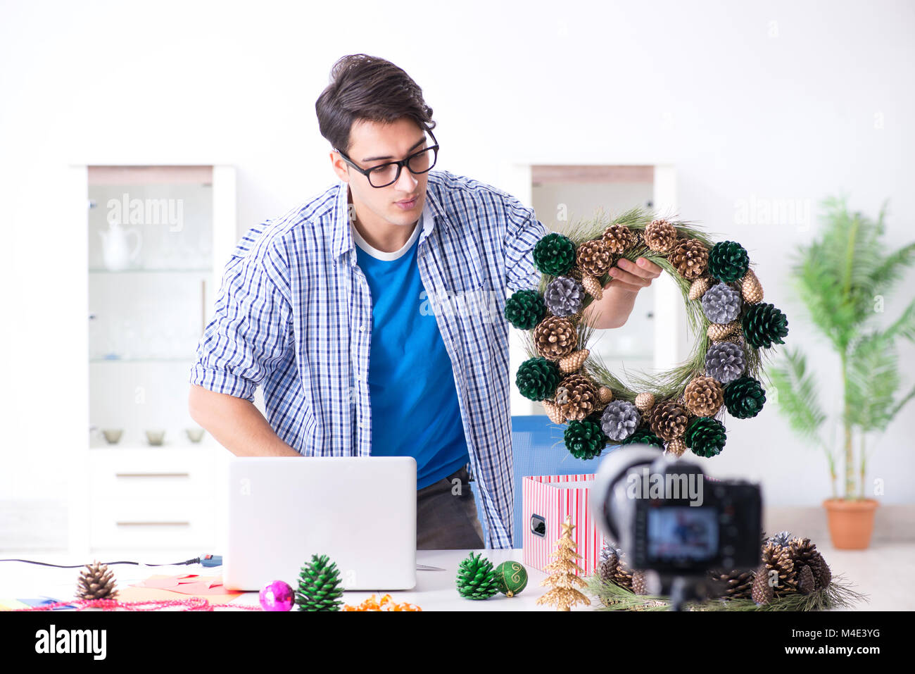 Young vlogger recording video doing christmas decoration Stock Photo ...