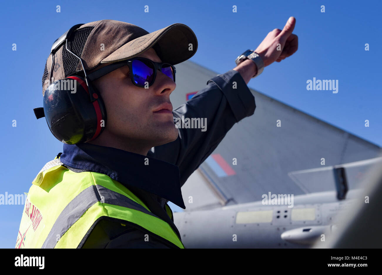 A Royal Air Force crew chief gives a thumbs-up to the pilot before ...