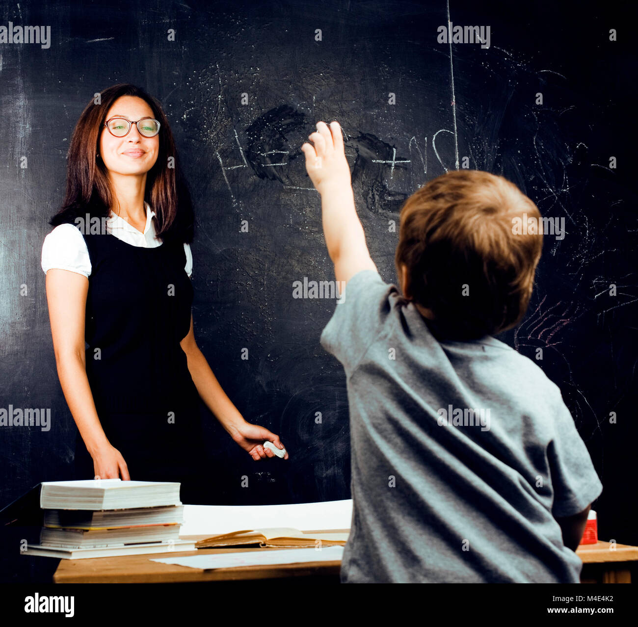 little cute boy with young teacher in classroom studying, lifest Stock ...