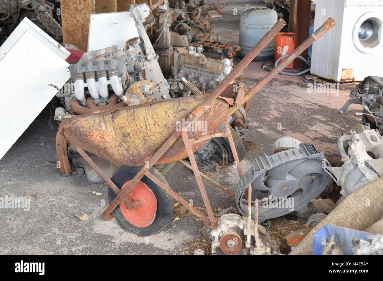 old broken and rusty wheelbarrow abandoned Stock Photo - Alamy