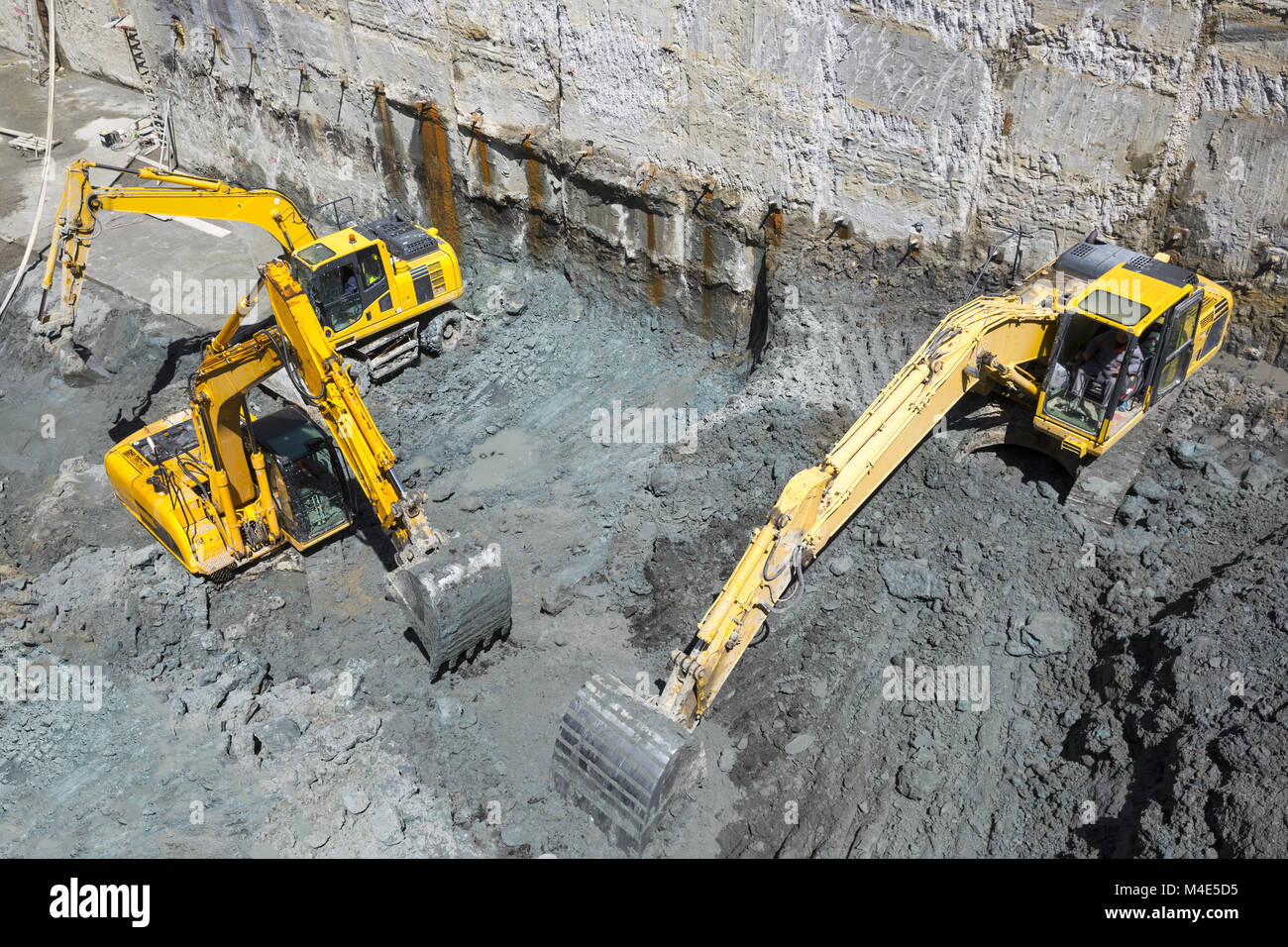 Excavators Baggers digging at a construction site Stock Photo - Alamy