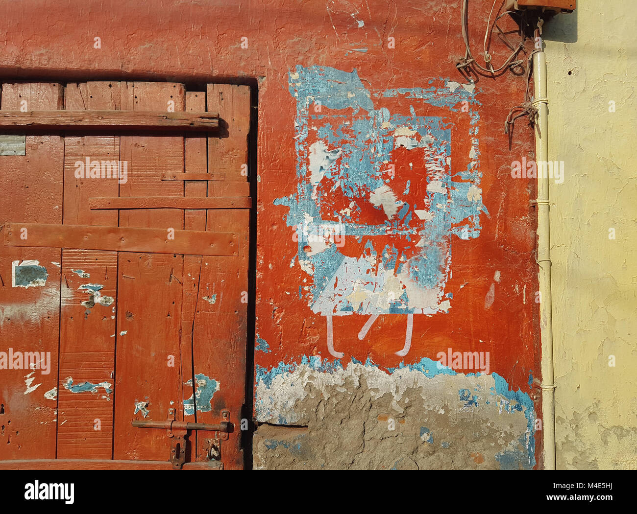 Abstract background of an old city wall, slums, a broken wooden door on ...
