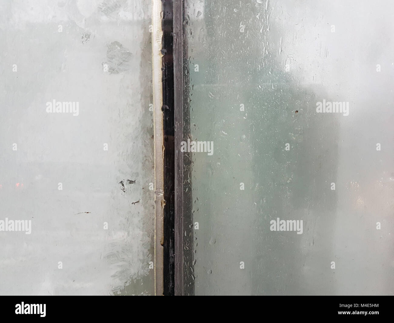 Abstract background of two gray glass surfaces with highlights and blue ...