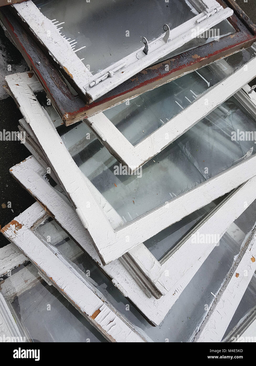 Dump, garbage: old wooden window frames of white color with cloudy gray ...