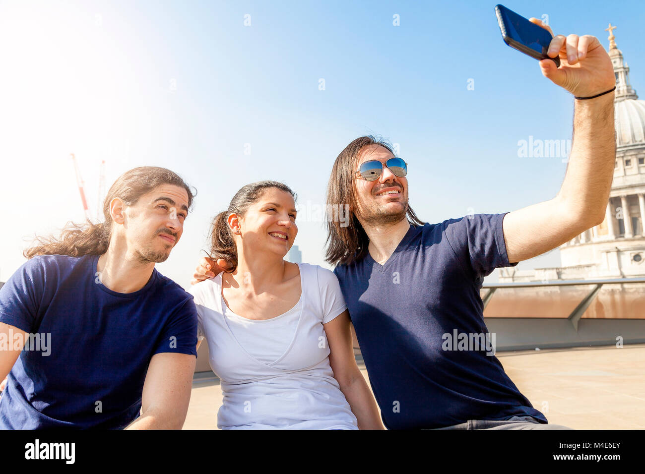 group of three young friends take a selfie on a london terrace Stock ...