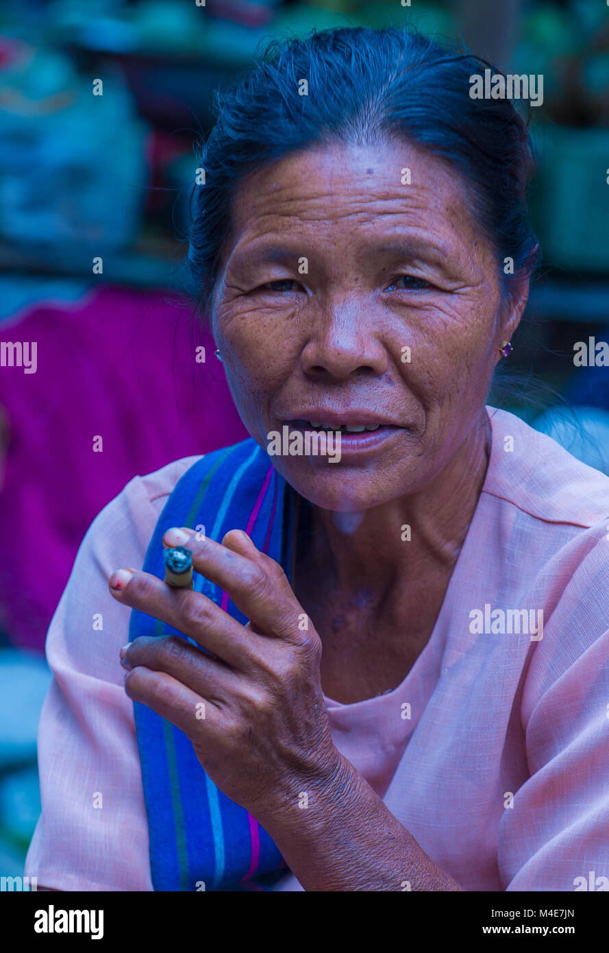 Woman smoking a cheroot cigar in market in bagan, Myanmar Stock Photo ...