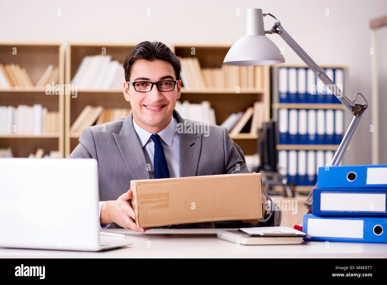 Businessman opening package in office hi-res stock photography and ...