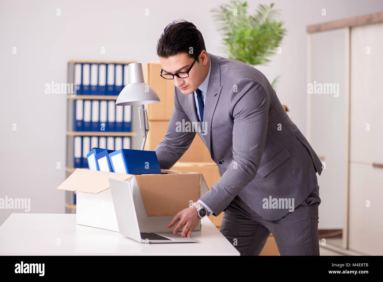 Young handsome businessman moving offices Stock Photo - Alamy