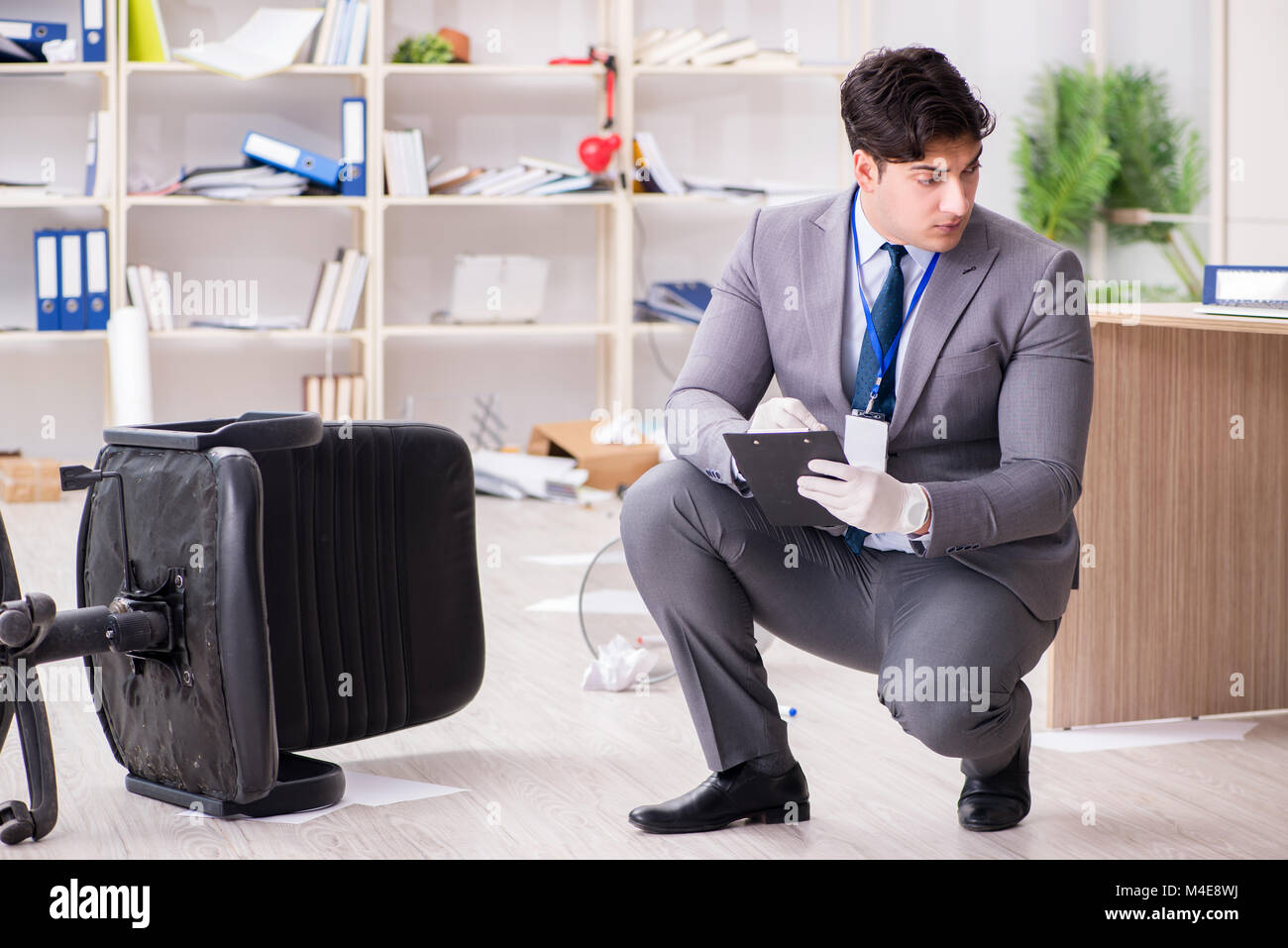 Young man during crime investigation in office Stock Photo - Alamy