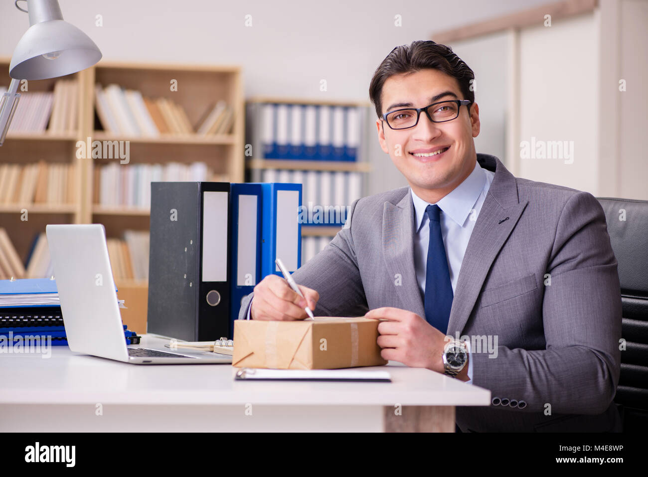 Businessman opening package in office hi-res stock photography and ...