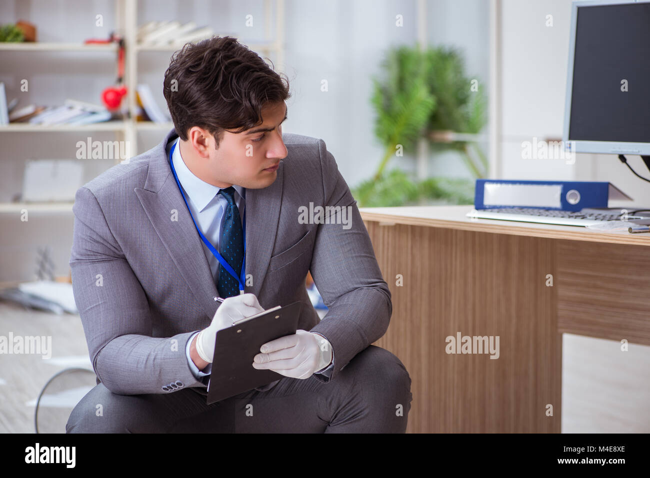 Young man during crime investigation in office Stock Photo - Alamy