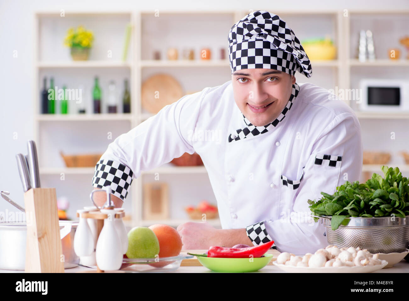 Young male cook working in the kitchen Stock Photo - Alamy