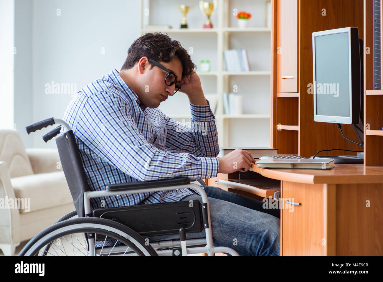 Disabled student studying at home on wheelchair Stock Photo - Alamy