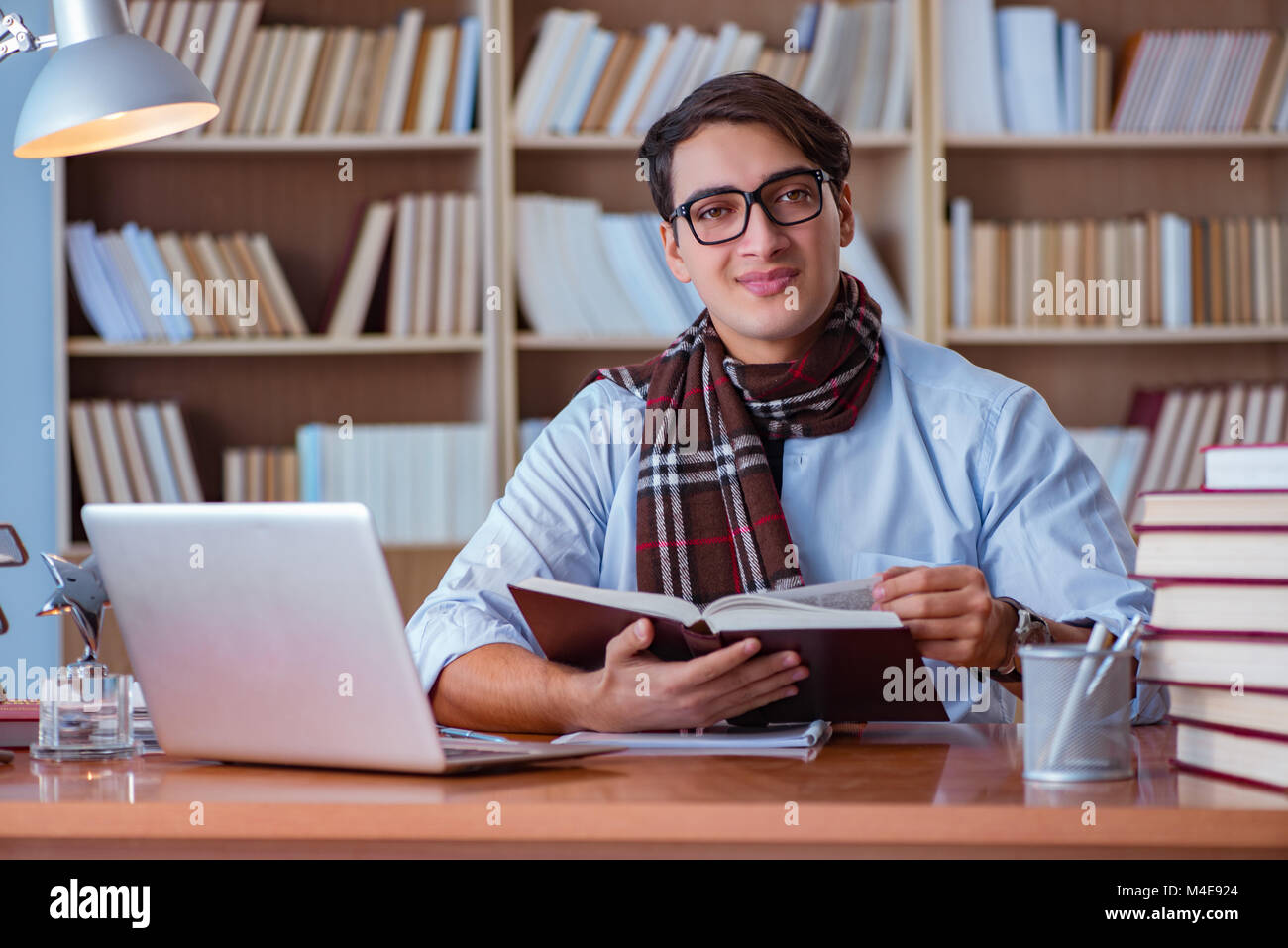 Young book writer writing in library Stock Photo - Alamy