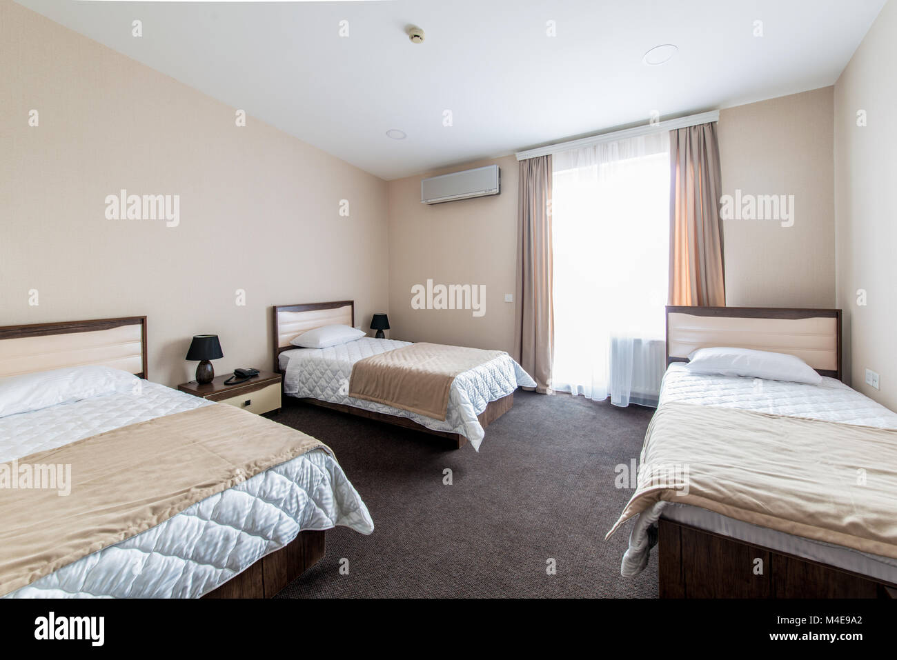 Triple room in modern hotel Stock Photo - Alamy
