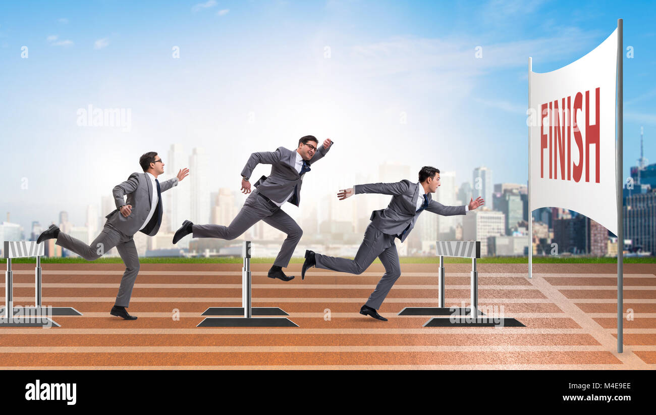 Businessman jumping over barriers in business concept Stock Photo - Alamy