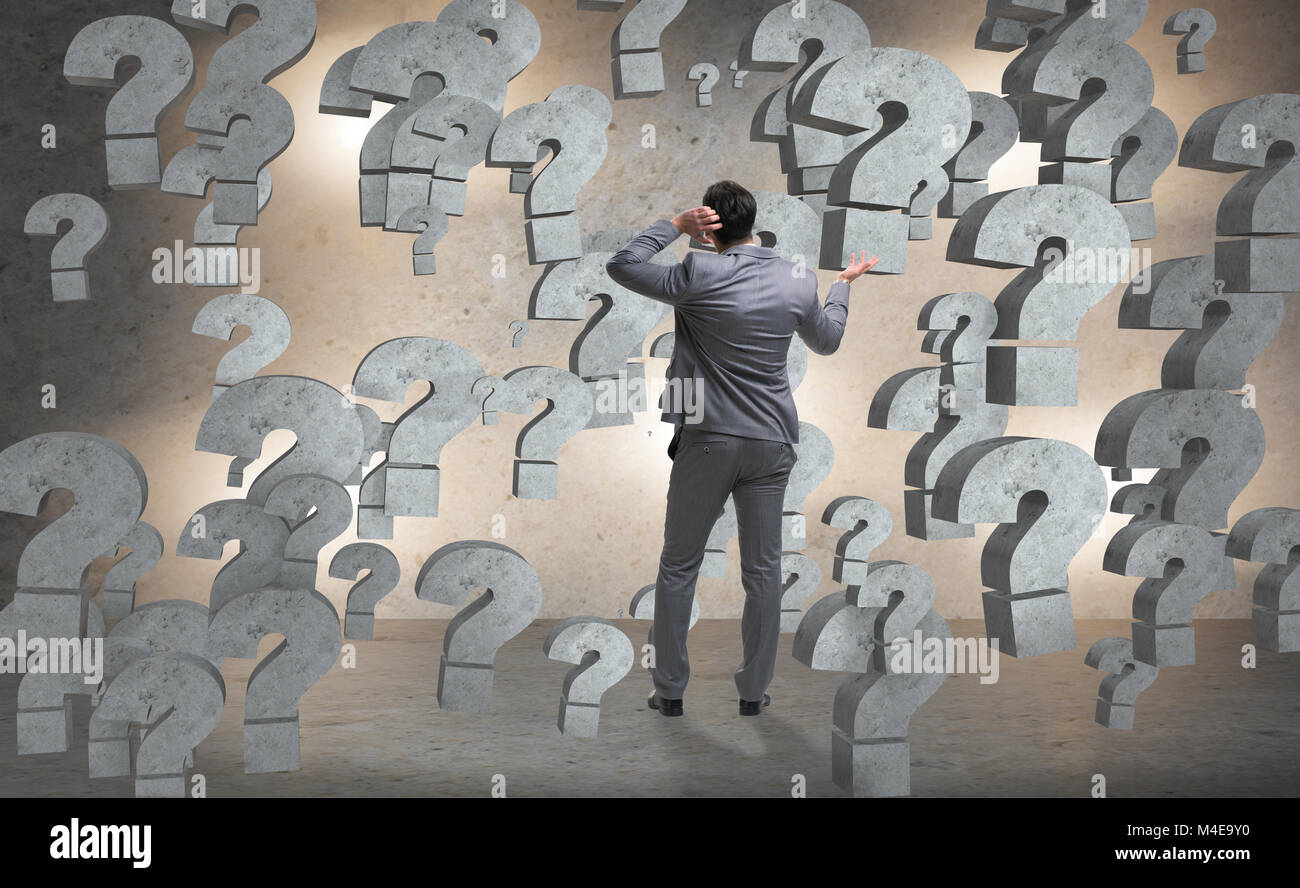 Businessman facing questions in business Stock Photo - Alamy