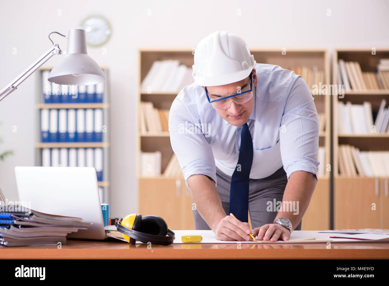 Engineer supervisor working on drawings in the office Stock Photo - Alamy