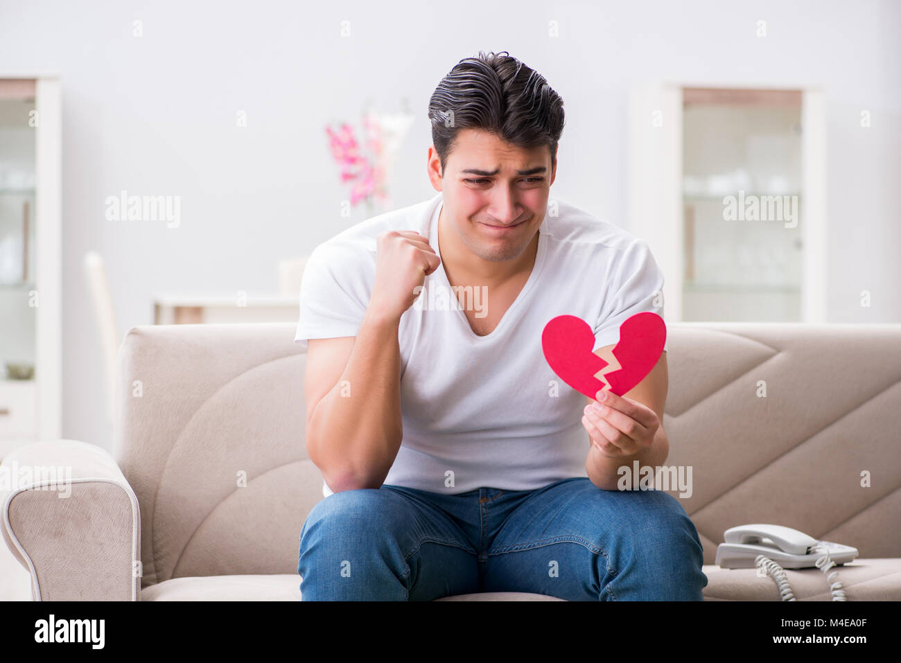 Young man in sad saint valentine concept Stock Photo - Alamy
