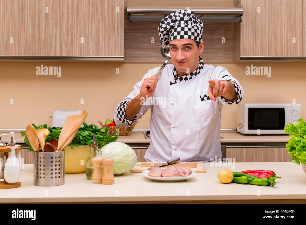Young chef working in the kitchen Stock Photo - Alamy