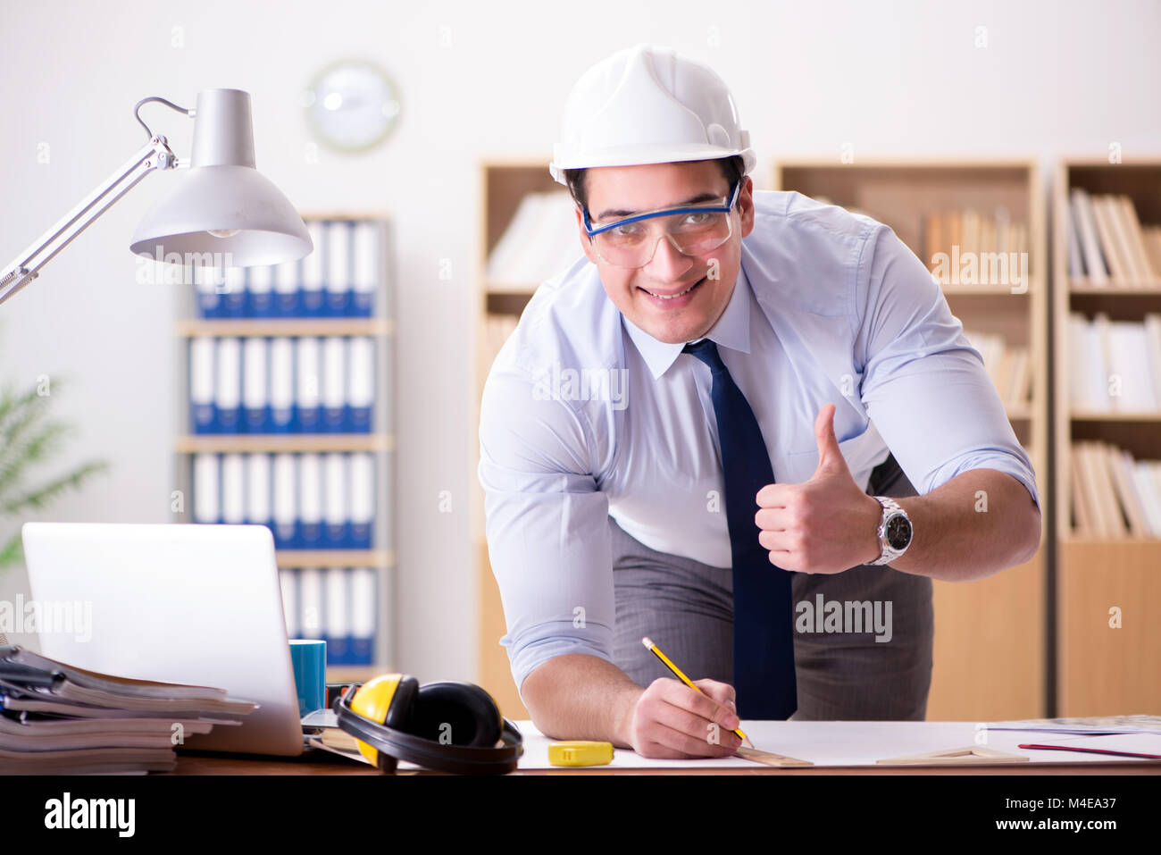 Engineer supervisor working on drawings in the office Stock Photo - Alamy