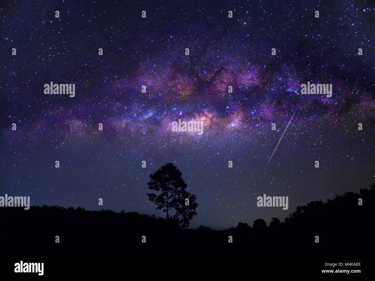 Rotating star galaxy mountain night blue sky Stock Photo - Alamy